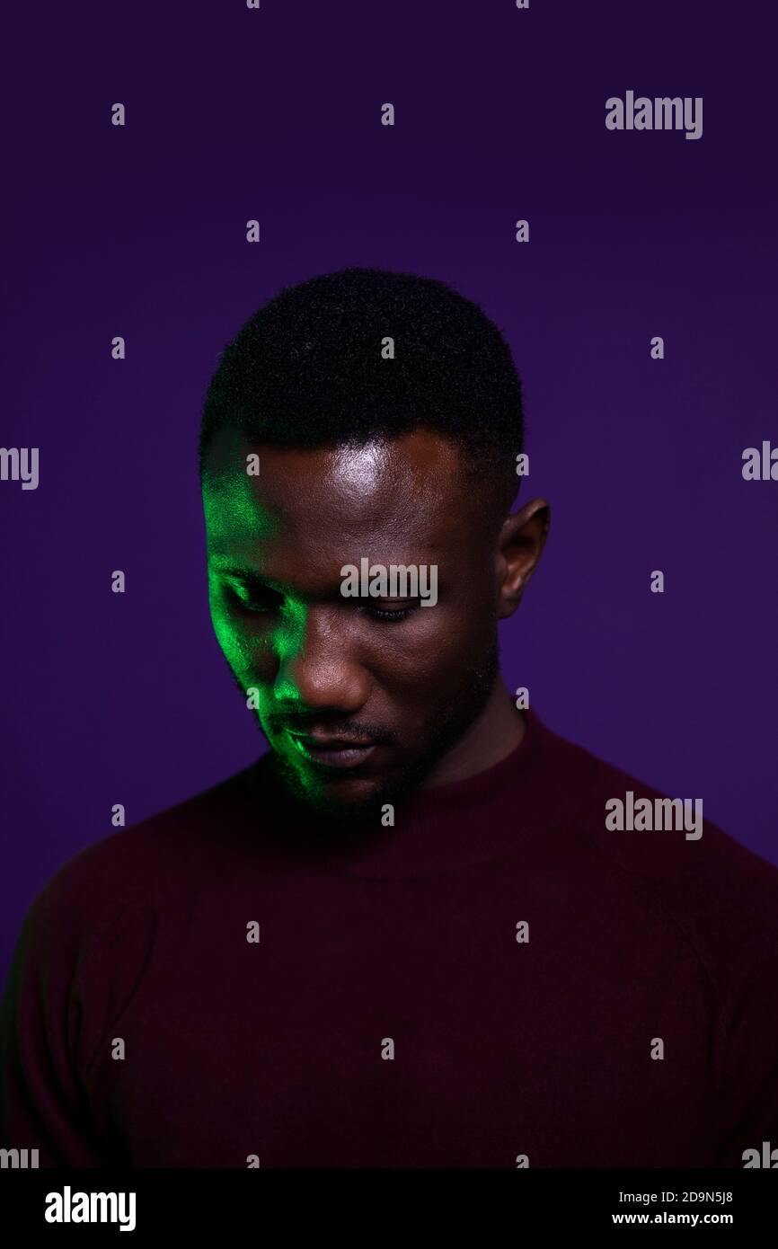 Black man with head bowed looking down. Portrait. Isolated. Medium shot ...