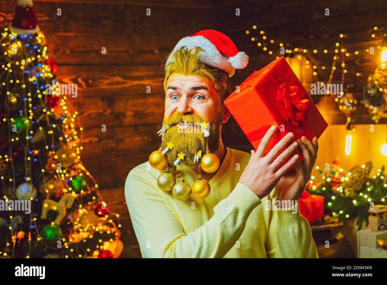 Christmas or New Year barber shop concept. Beard with bauble. Santa in ...