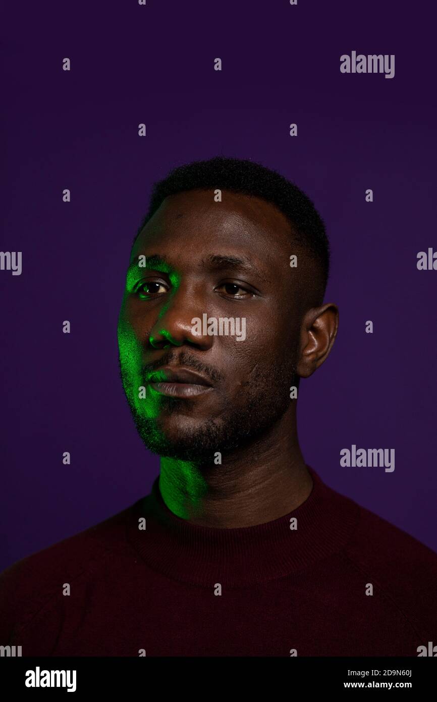 Face of black man with serious facial expression looking away. Isolated ...
