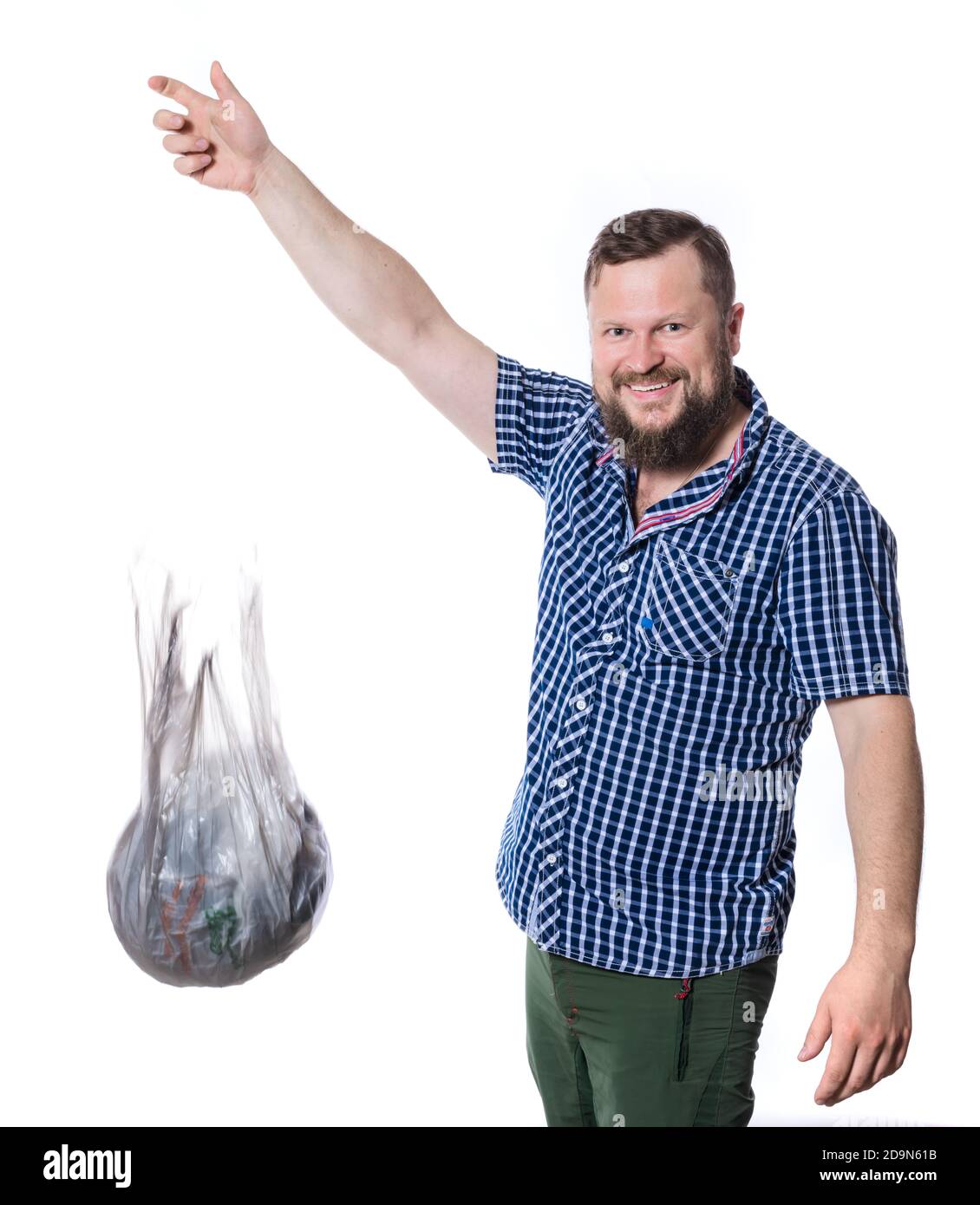 Joyful bearded man in shirt with plastic garbage package waste disposal ...