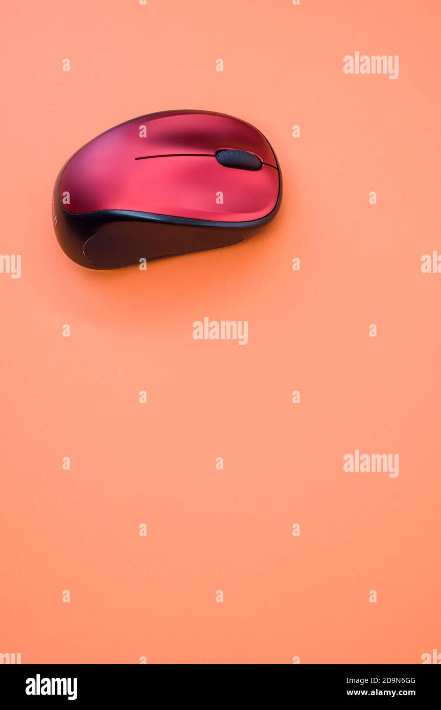 Vertical shot of a wireless mouse on an orange surface Stock Photo - Alamy