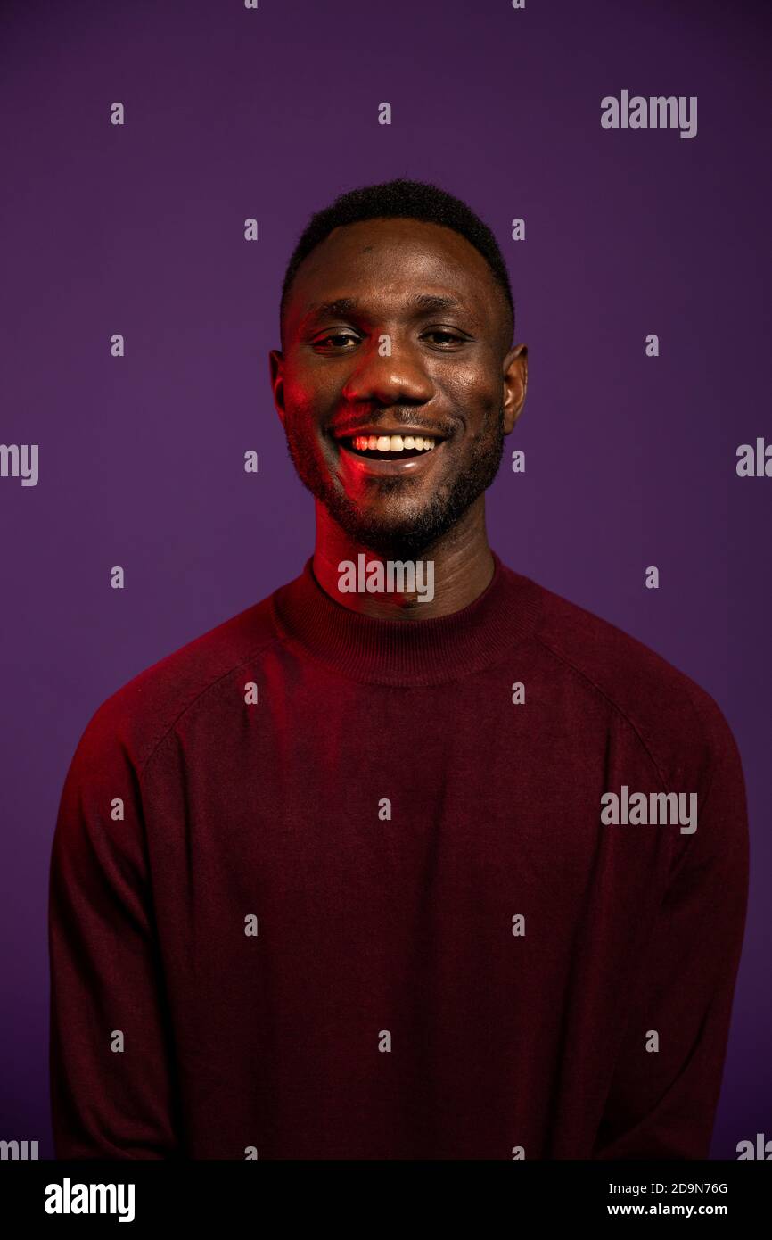 Portrait of handsome black man smiling for camera. Isolated background ...