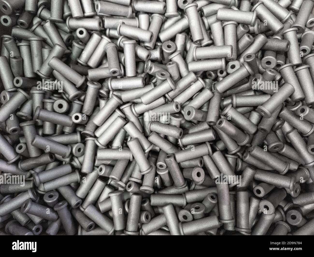 a pile of small sand blasted steel parts - close-up with selective ...