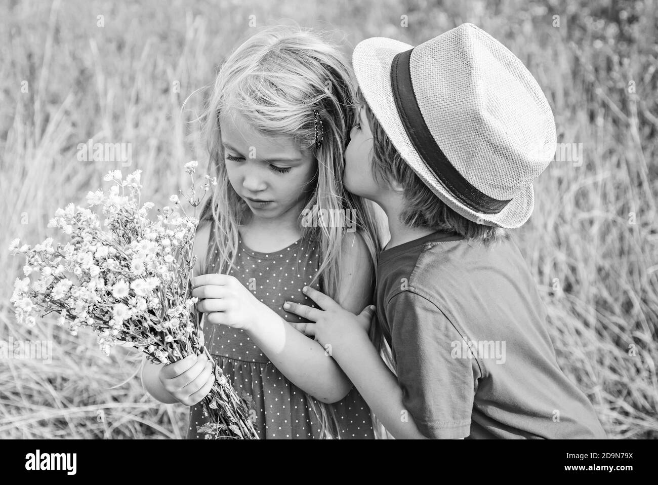 Happy Kid on summer field. Happy children girl and boy hug on meadow in ...