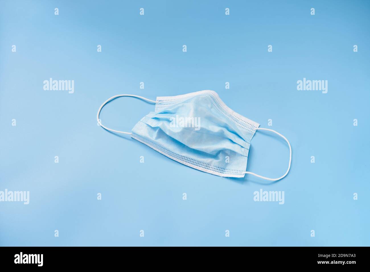 Isolated medical face mask on a blue background. Personal protective ...