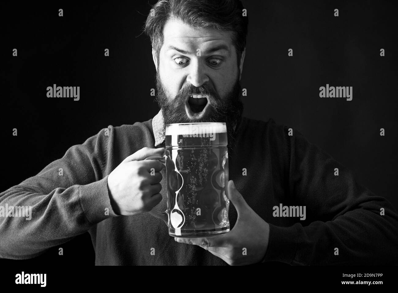 Emotional funny bearded drunk hipster holds craft bottled beer. Happy ...