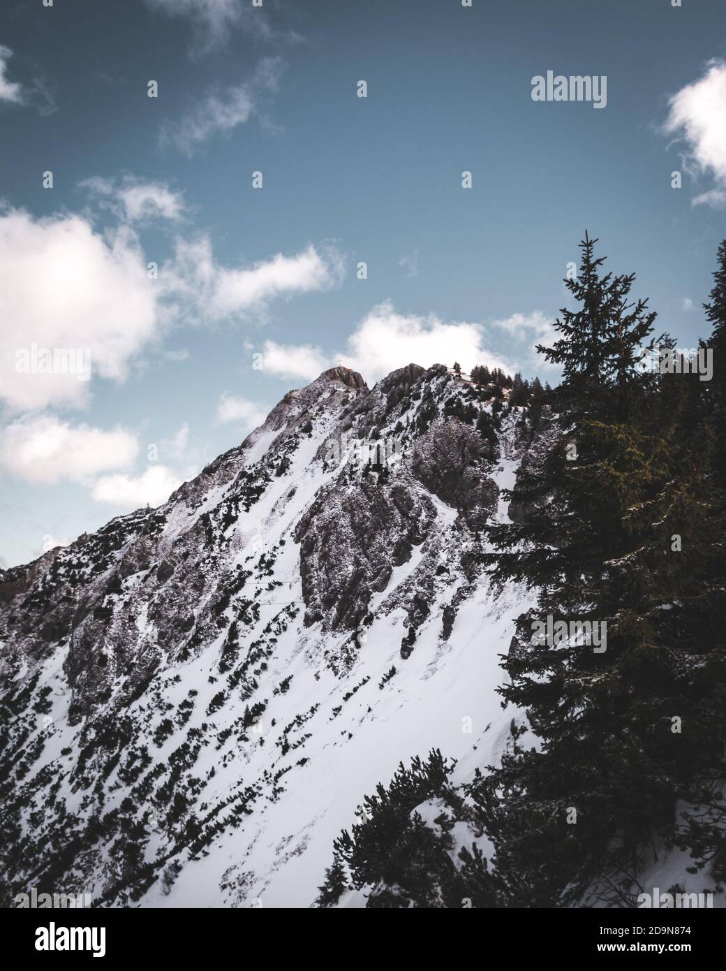 Mountain crest with blue sky and some clouds in the background and ...