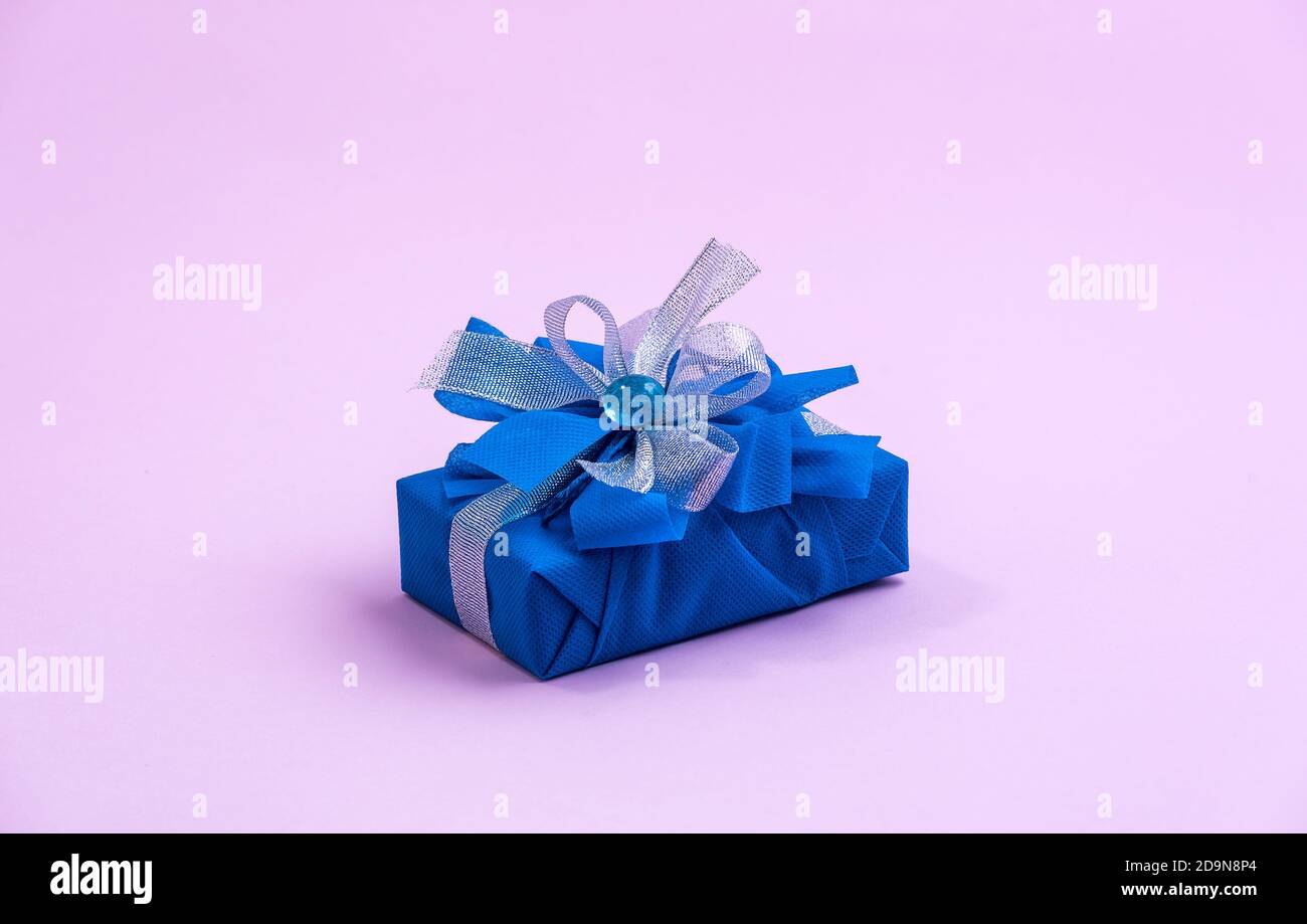 Classic blue surprise gift box with blue and white ribbon, background ...