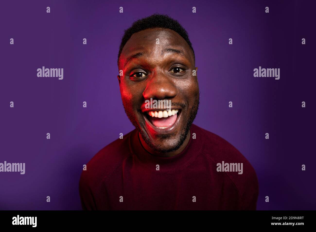 Young black man smiling with mouth wide open. Isolated background ...