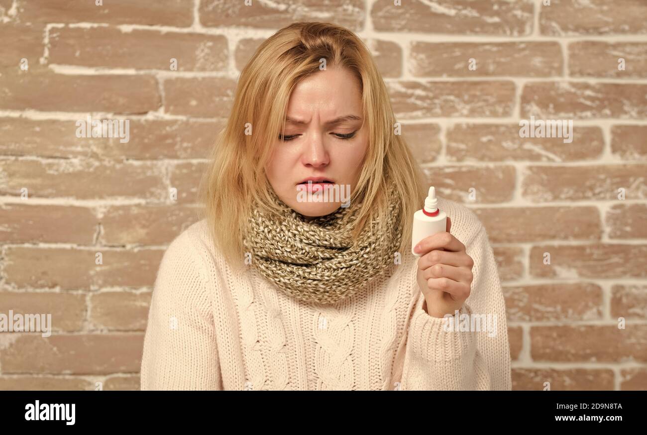 Stuffy nose. Sick woman injecting drops into nose. Suffering from ...