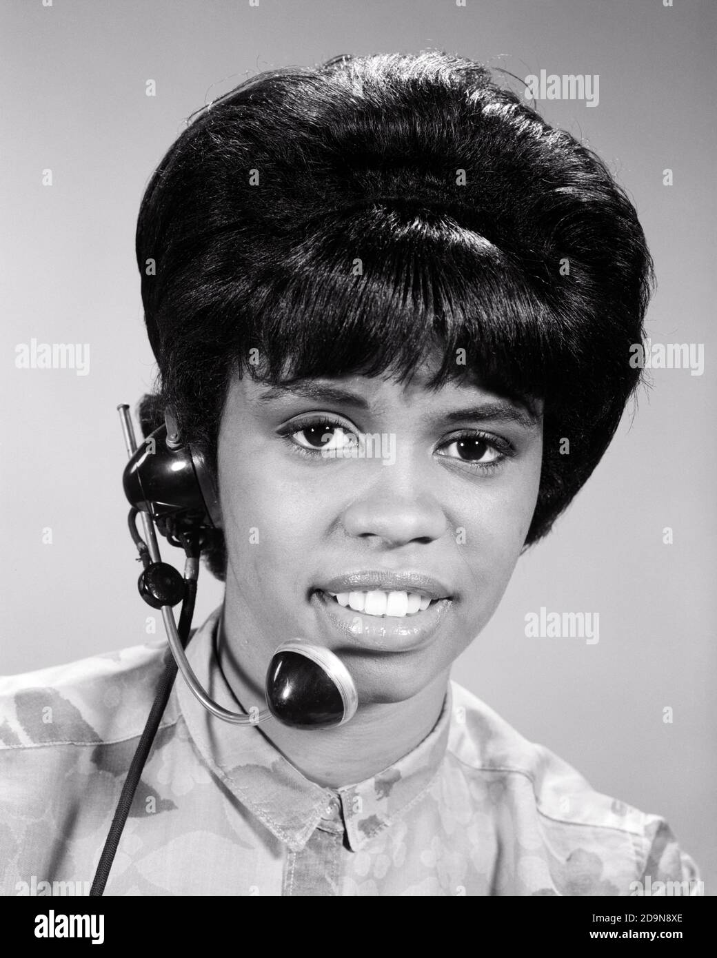 1960s AFRICAN-AMERICAN WOMAN TELEPHONE OPERATOR RECEPTIONIST LOOKING AT ...