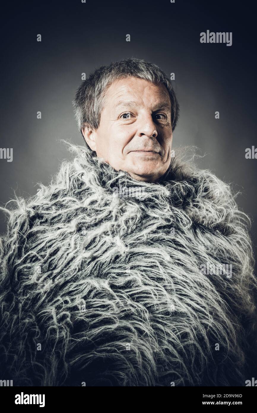 Solid middle-aged man in a fur mantle studio portrait Stock Photo - Alamy