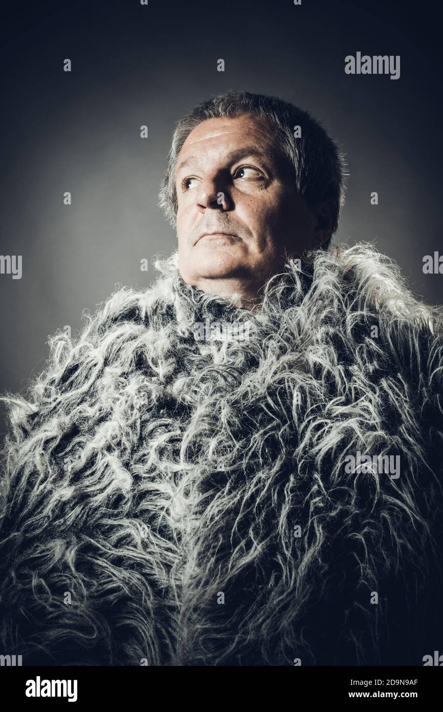 Solid middle-aged man in a fur mantle studio portrait Stock Photo - Alamy