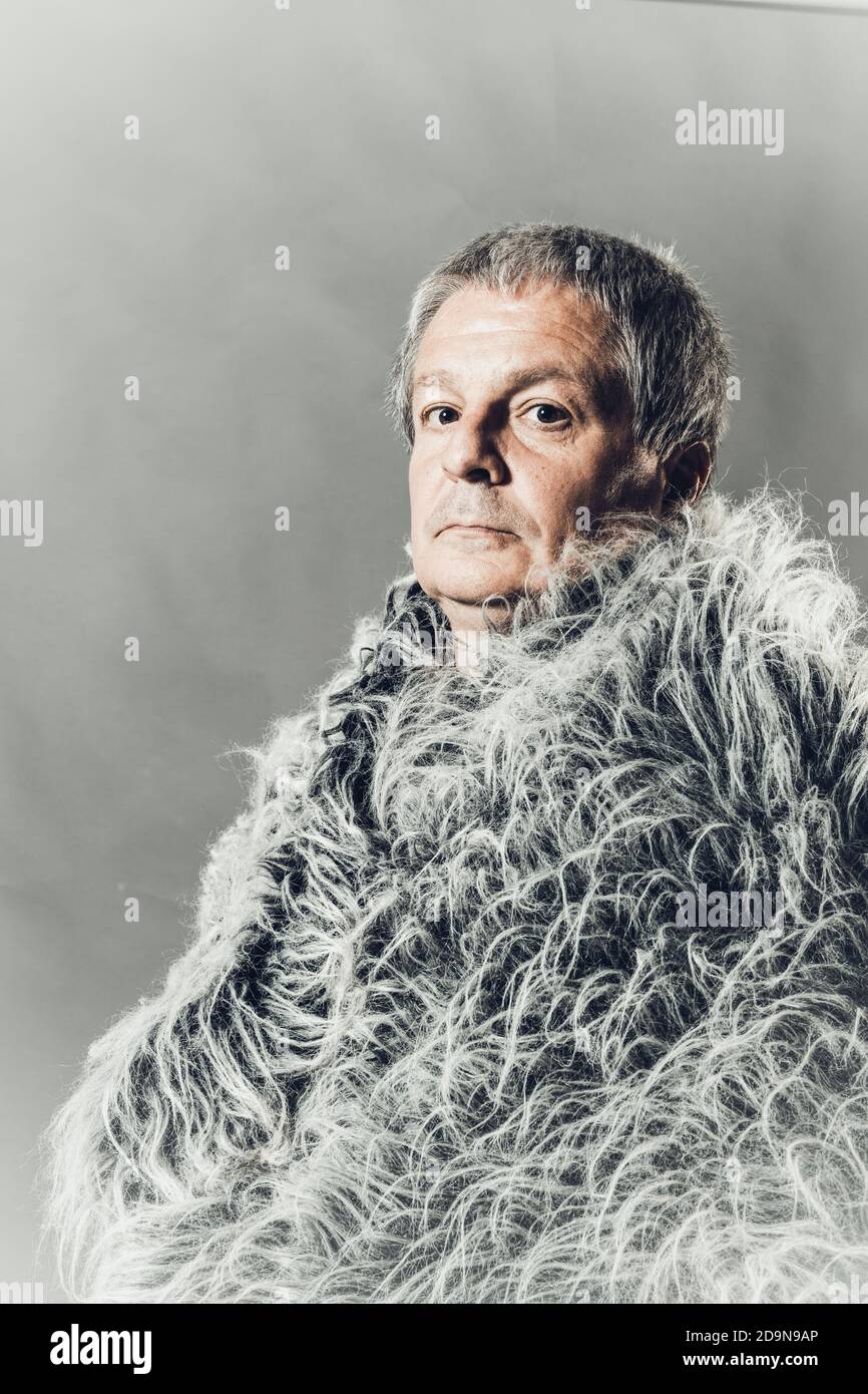 Solid middle-aged man in a fur mantle studio portrait Stock Photo - Alamy