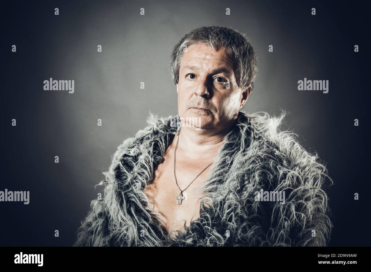 Solid middle-aged man in a fur mantle studio portrait Stock Photo - Alamy
