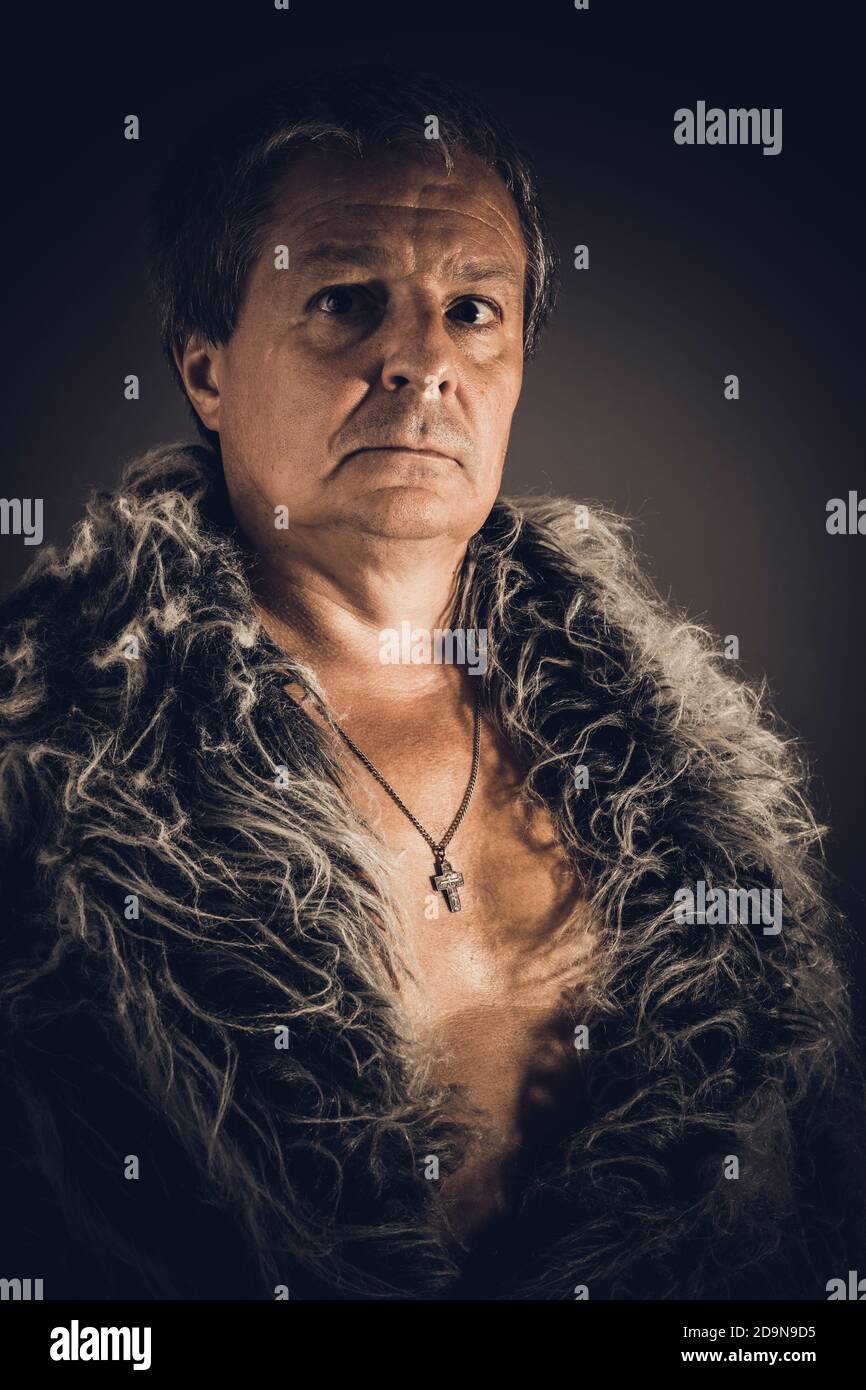 Solid middle-aged man in a fur mantle studio portrait Stock Photo - Alamy