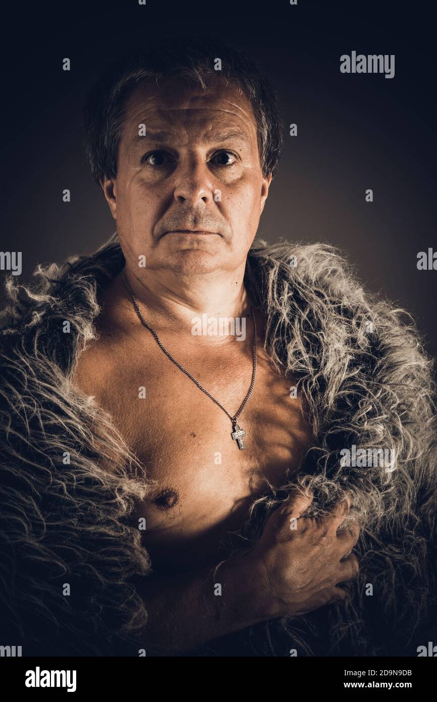 Solid middle-aged man in a fur mantle studio portrait Stock Photo - Alamy