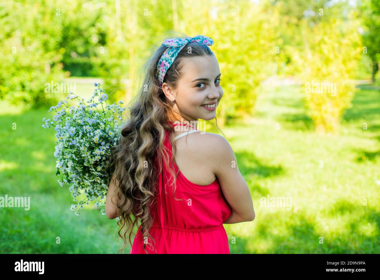 Time to have adventure. Happy girl smile with flowers on natural ...