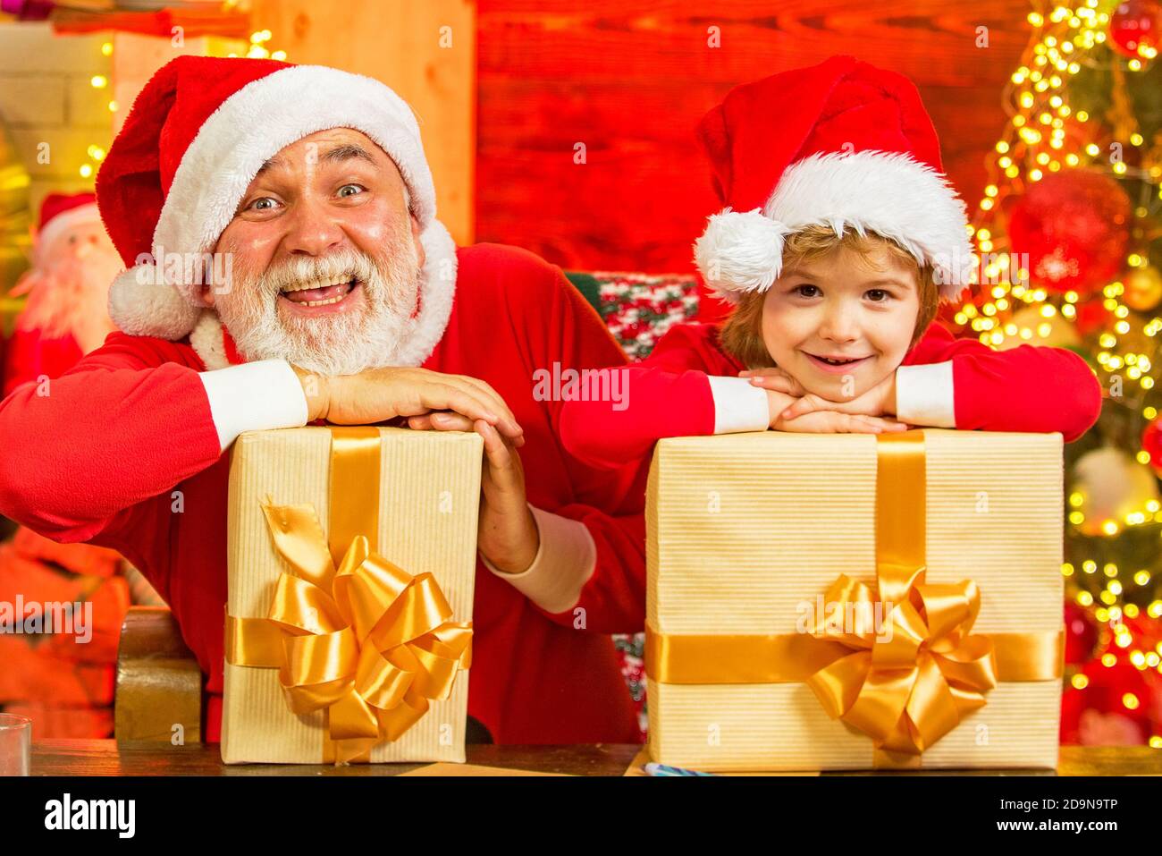 Adorable child son play with Santa dad at home. Winter holidays. Santa ...