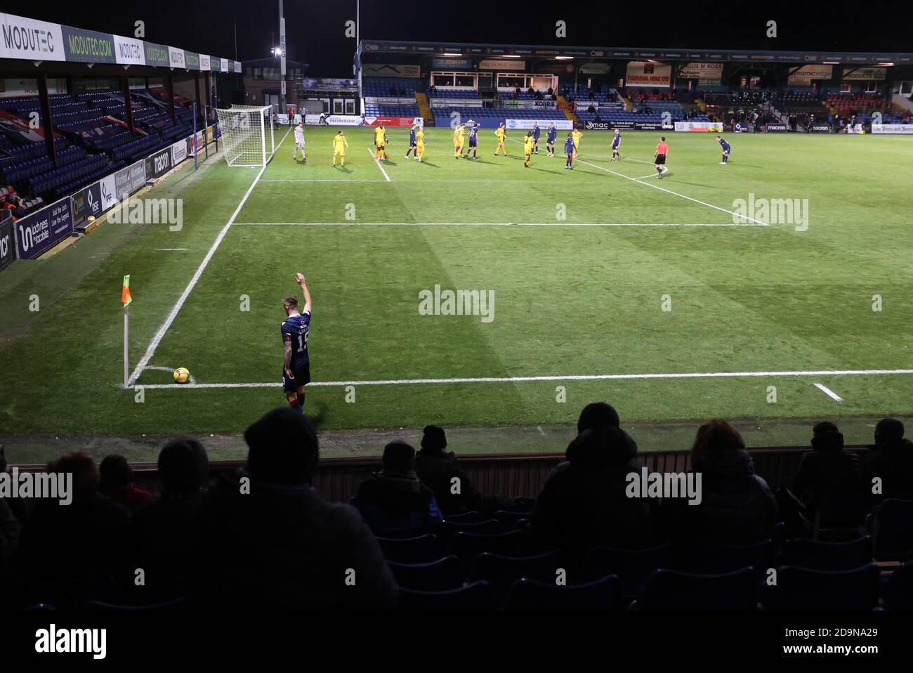 Fans watch Ross County's Charlie Lakin takes a corner during the ...