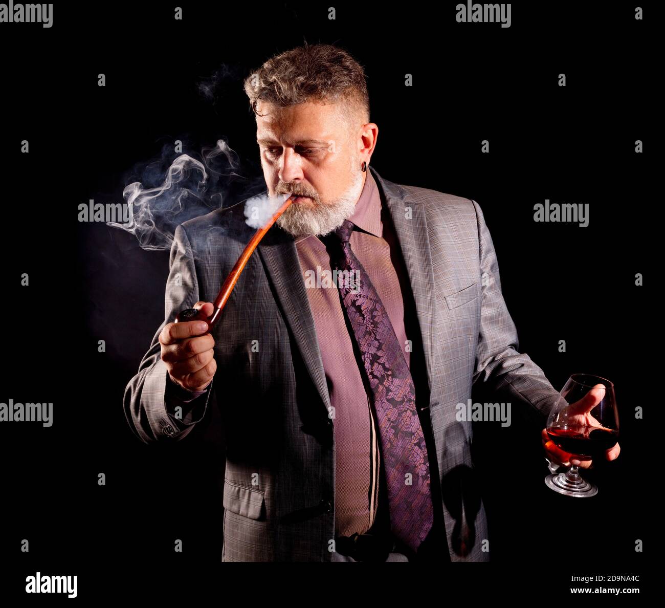 Mature businessman smoking pipe hi-res stock photography and images - Alamy