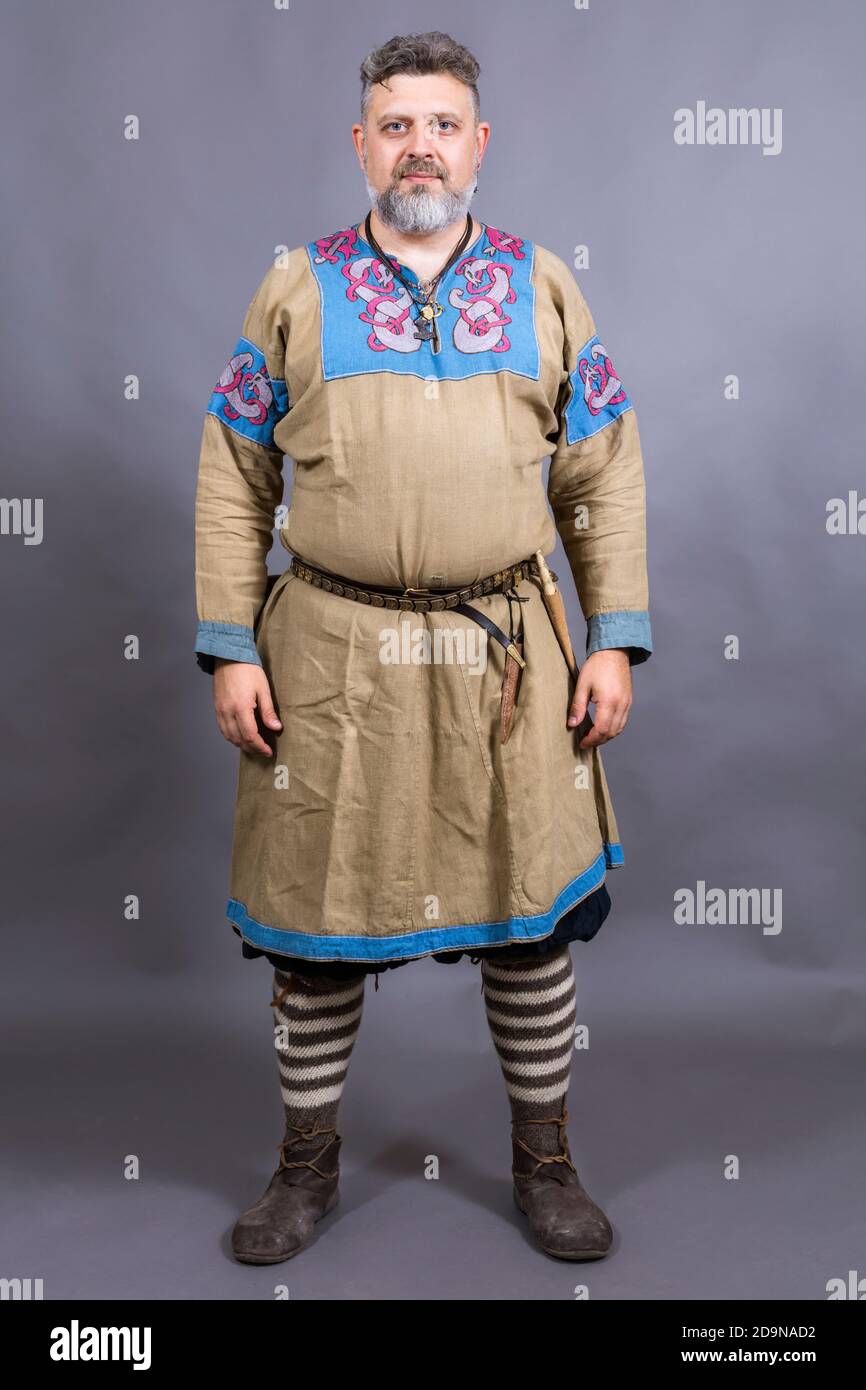 Mature bearded man in traditional historic clothes studio portrait ...