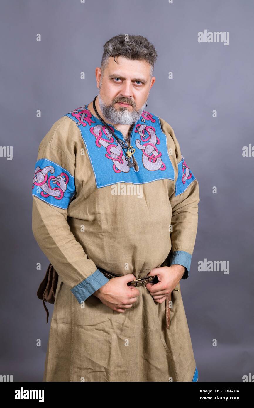 Mature bearded man in traditional historic clothes studio portrait ...