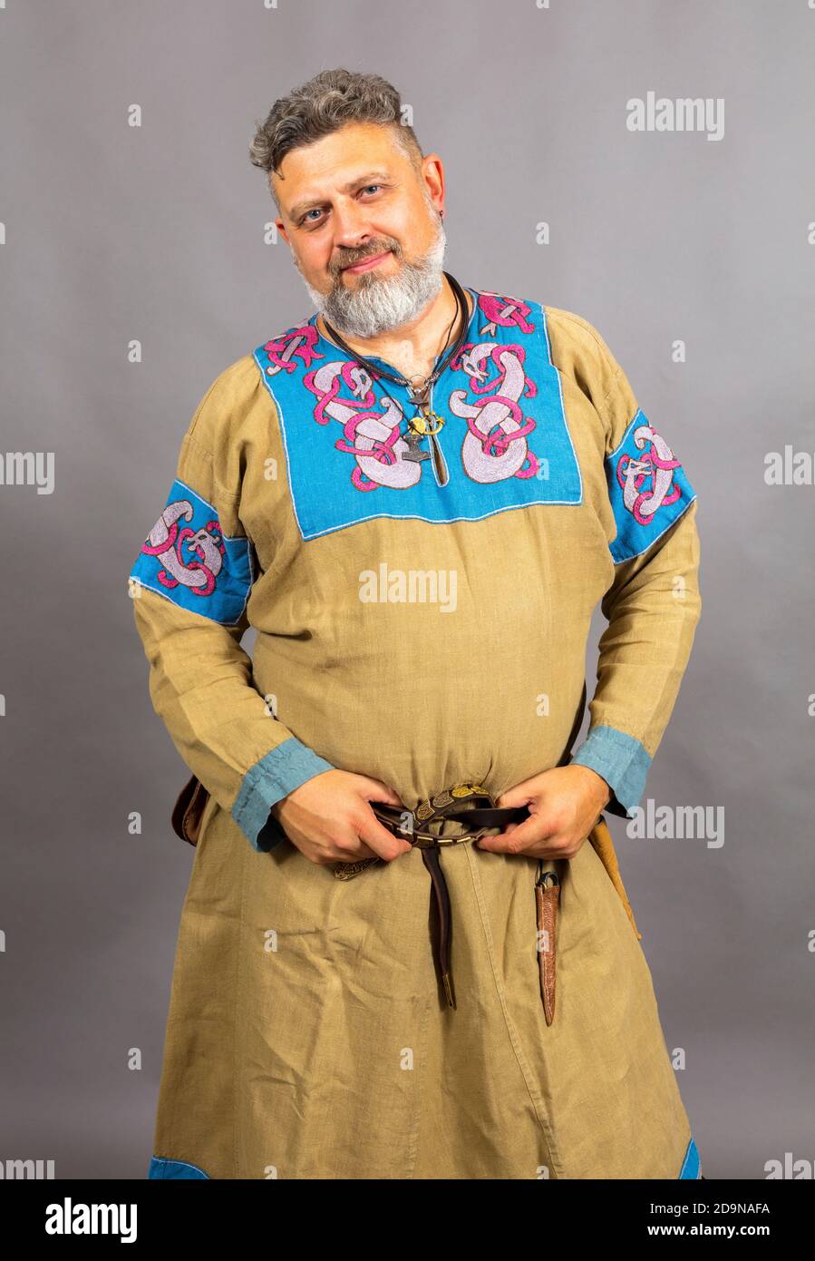 Mature bearded man in traditional historic clothes studio portrait ...