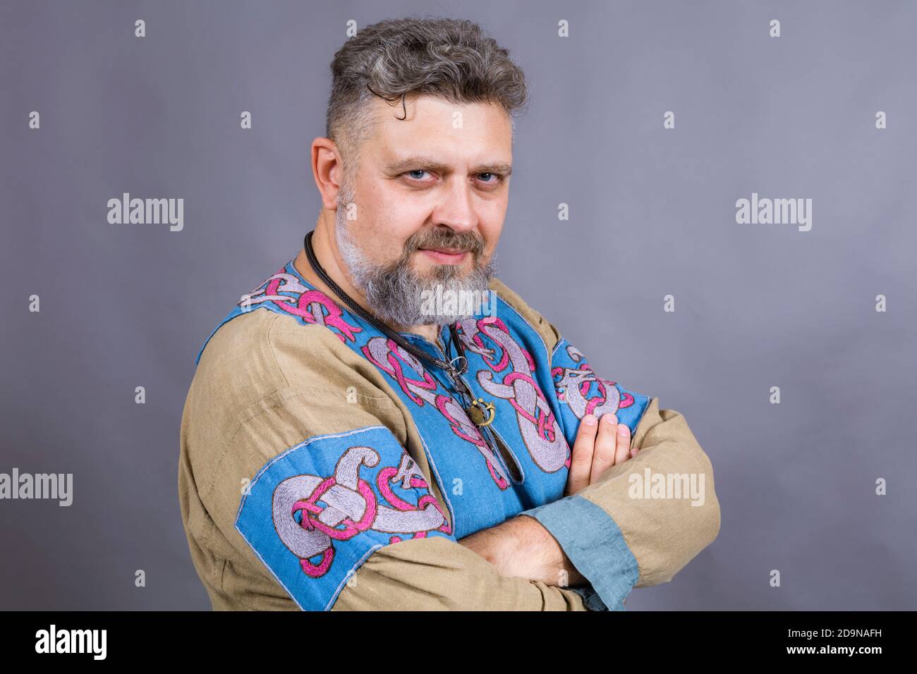 Mature bearded man in traditional historic clothes studio portrait ...