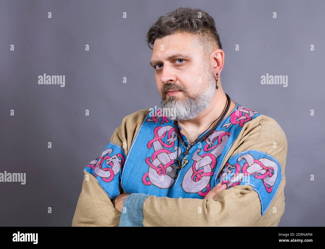 Mature bearded man in traditional historic clothes studio portrait ...