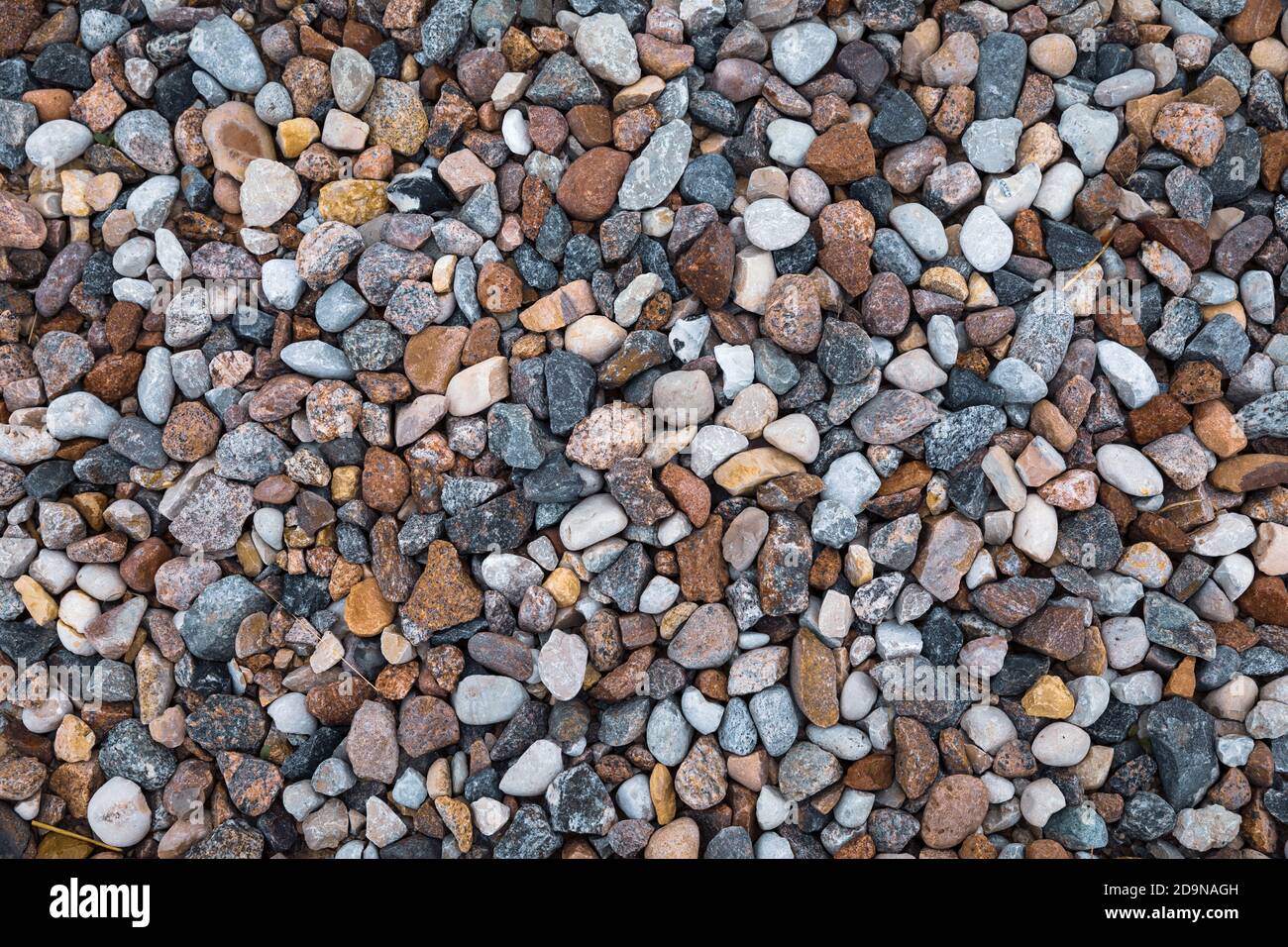 Different colored rocks and pebbles on a beach. Various colors and ...