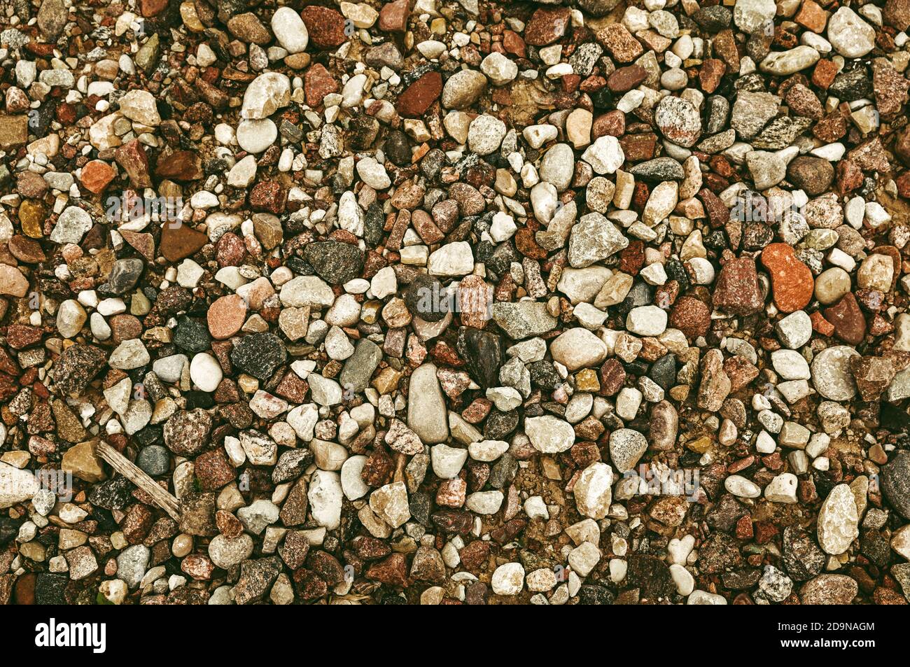 Different colored rocks and pebbles on a beach. Various colors and ...
