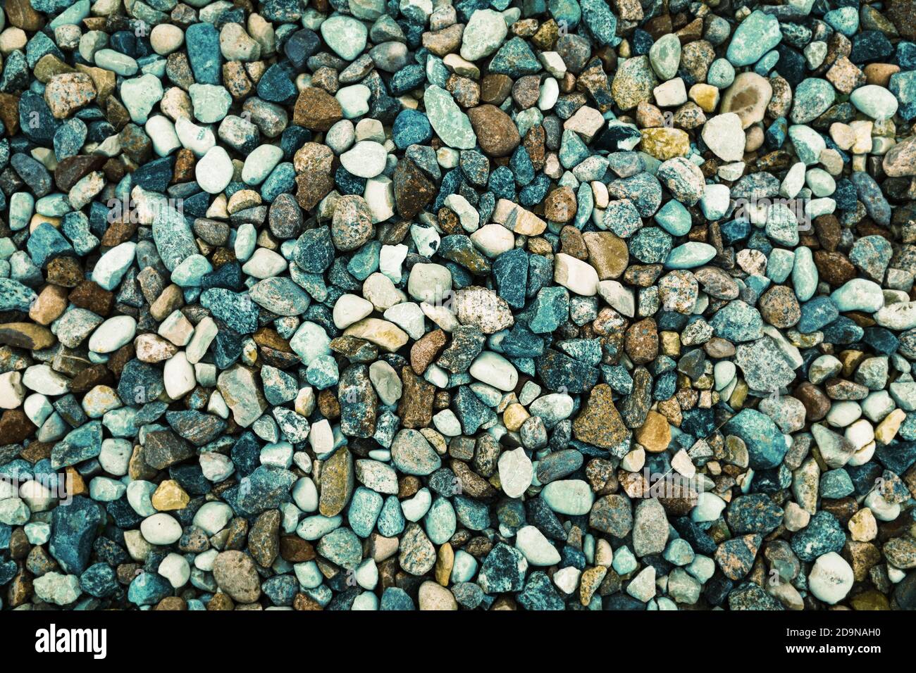 Different colored rocks and pebbles on a beach. Various colors and ...