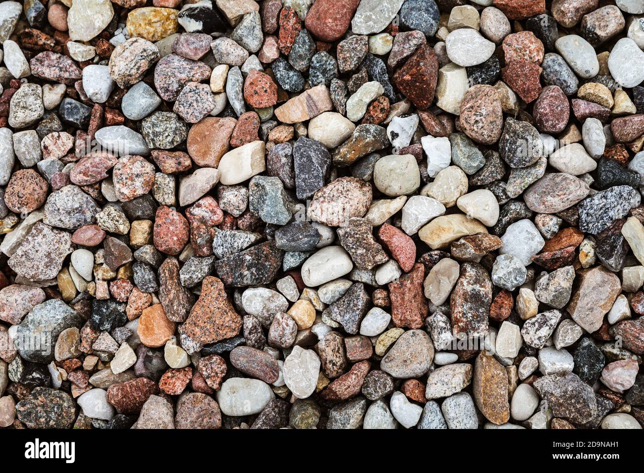 Different colored rocks and pebbles on a beach. Various colors and ...