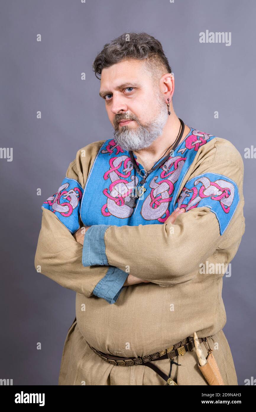 Mature bearded man in traditional historic clothes studio portrait ...