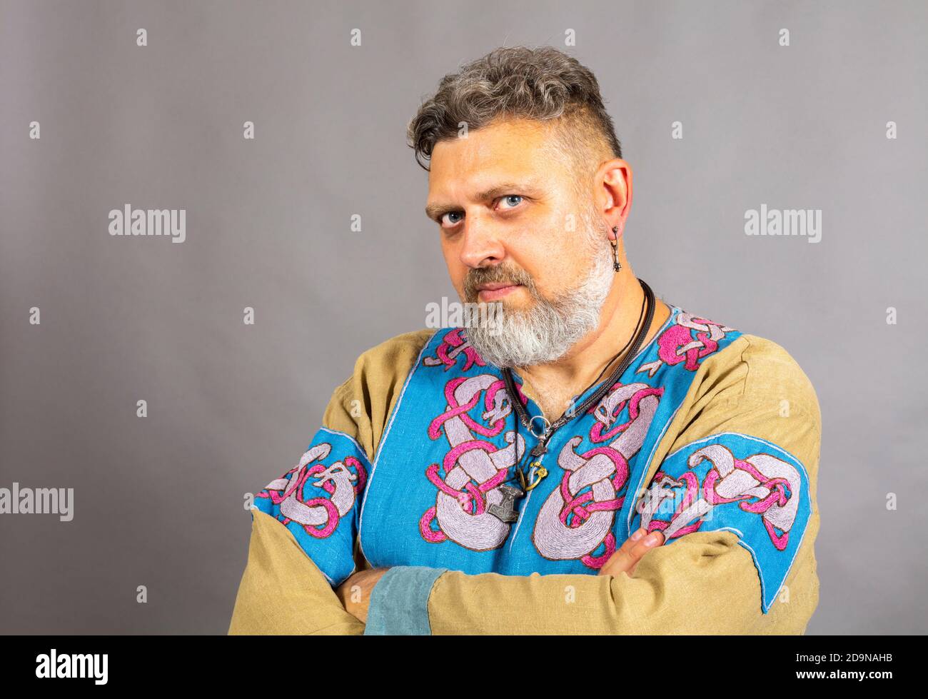 Mature bearded man in traditional historic clothes studio portrait ...