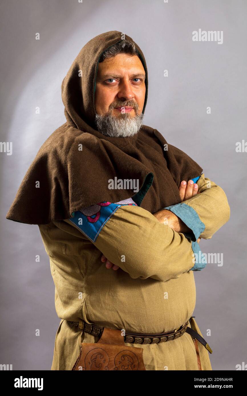 Mature bearded man in traditional historic clothes studio portrait ...