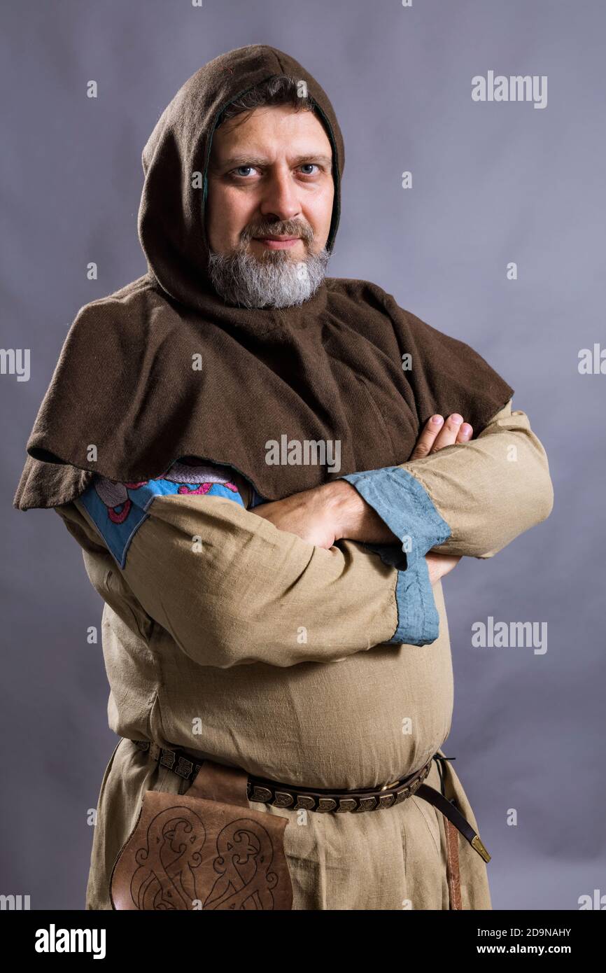 Mature bearded man in traditional historic clothes studio portrait ...