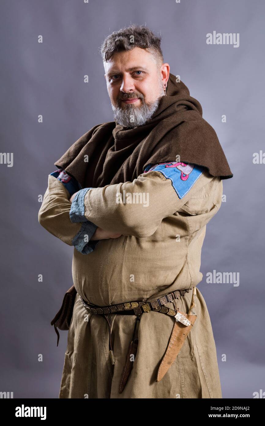 Mature bearded man in traditional historic clothes studio portrait ...