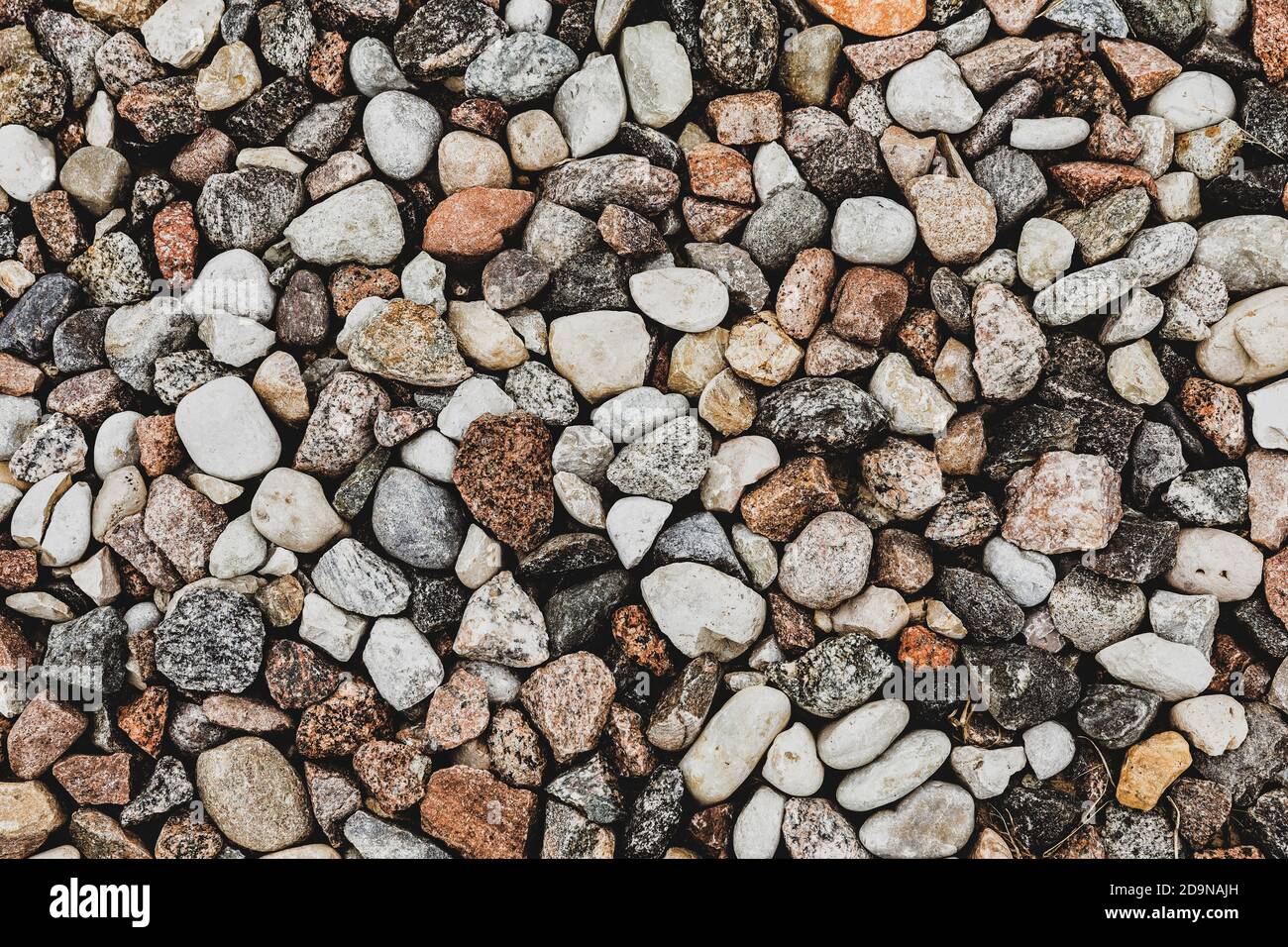 Different colored rocks and pebbles on a beach. Various colors and ...