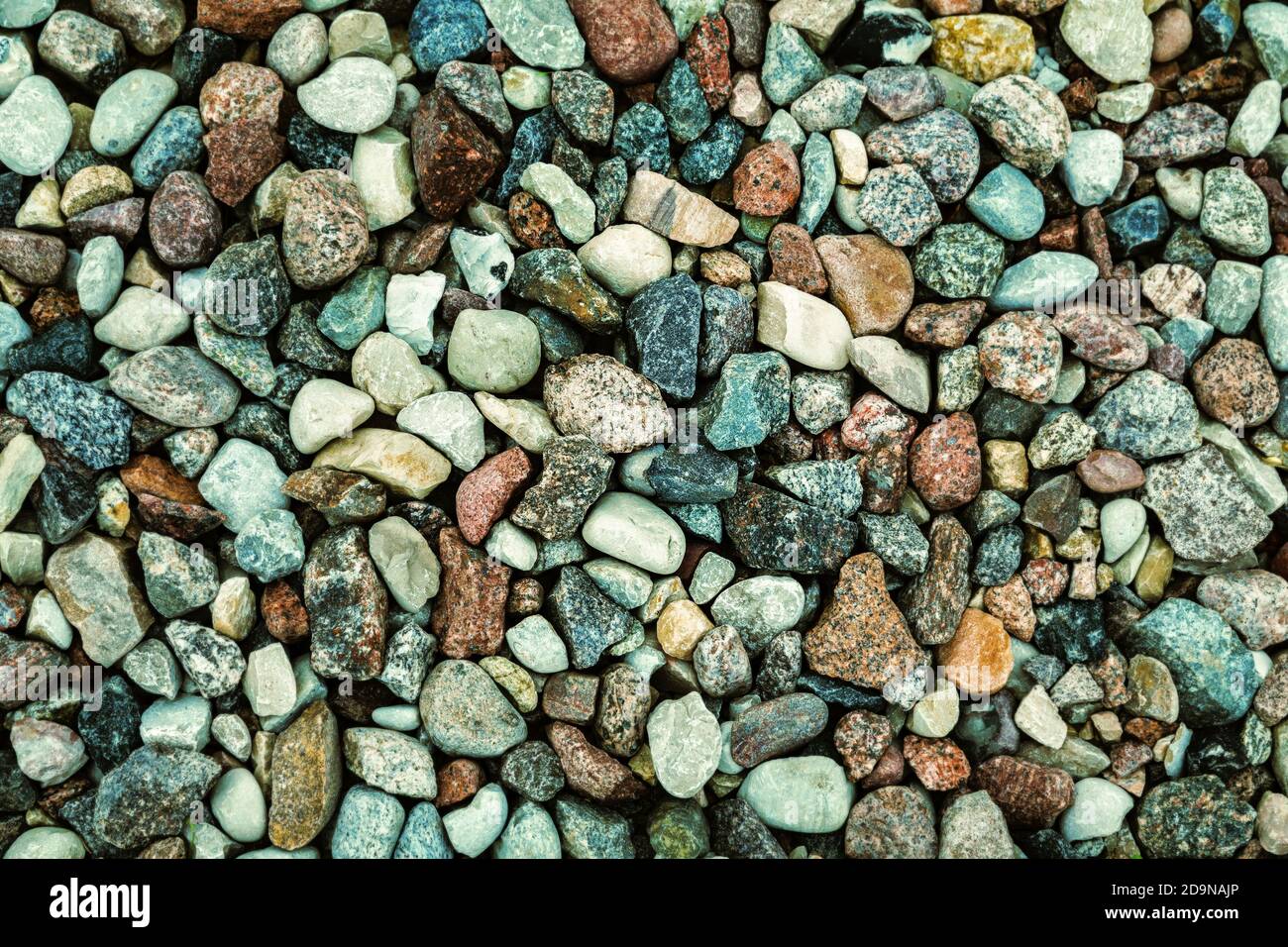 Different colored rocks and pebbles on a beach. Various colors and ...