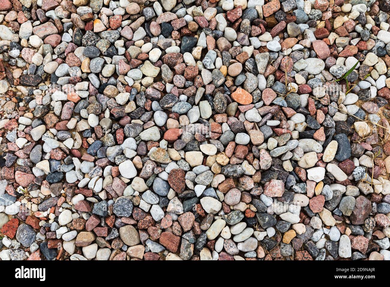 Different colored rocks and pebbles on a beach. Various colors and ...