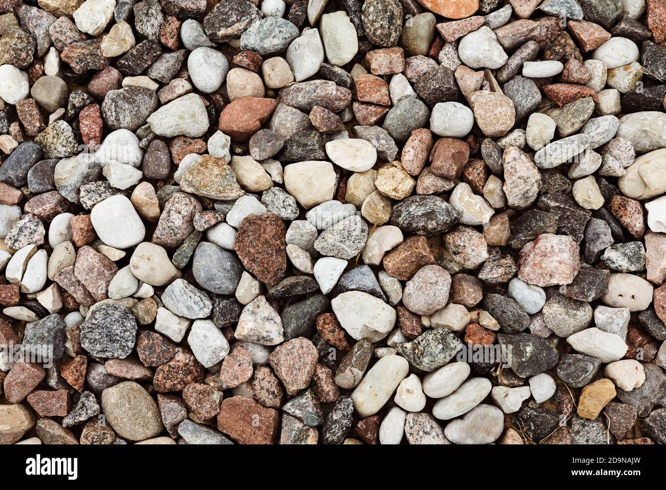 Different colored rocks and pebbles on a beach. Various colors and ...