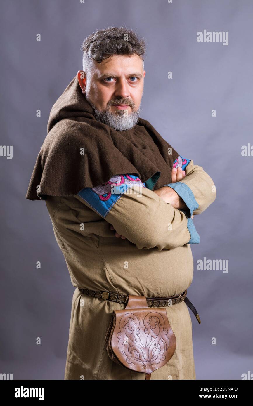 Mature bearded man in traditional historic clothes studio portrait ...