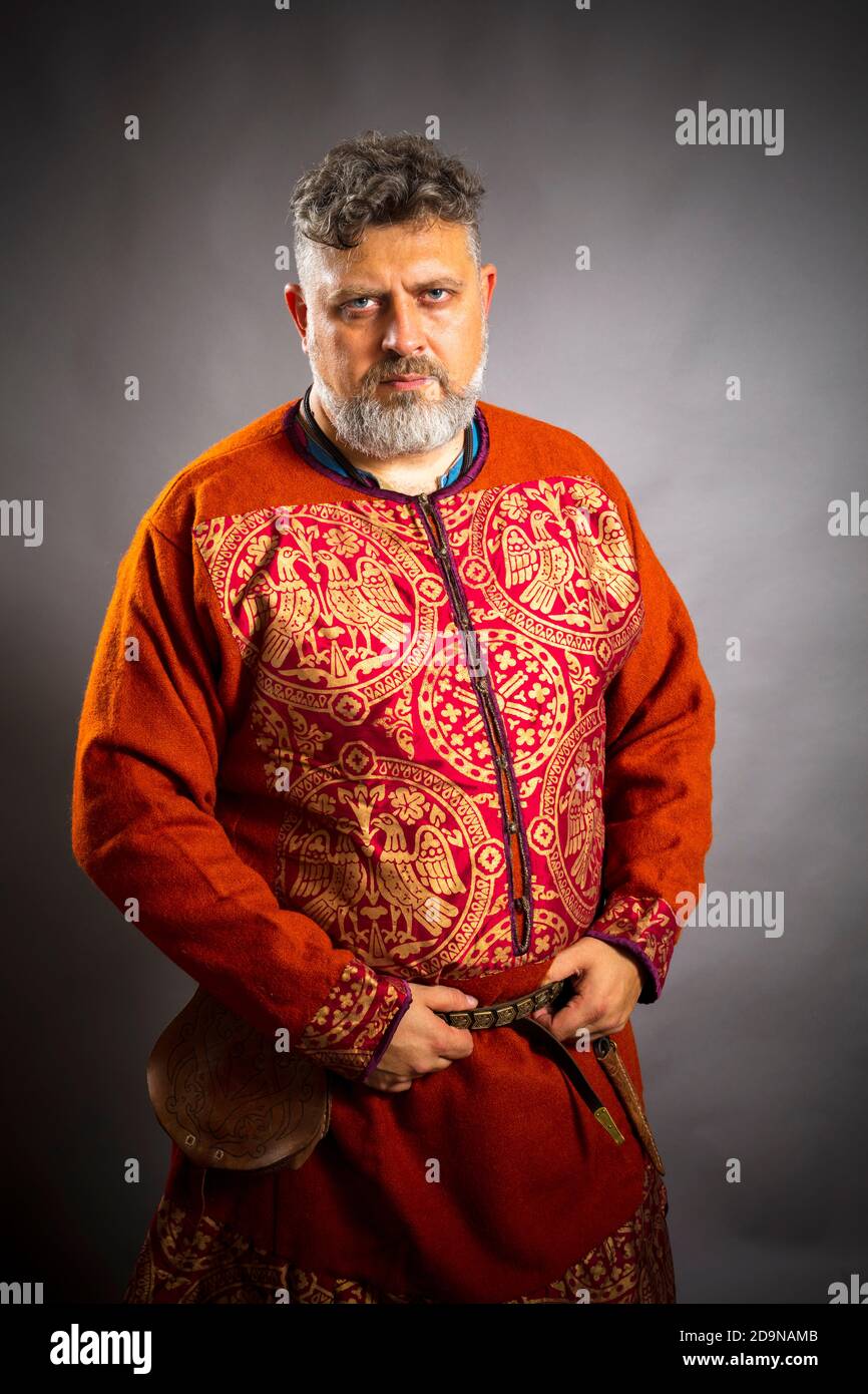 Mature bearded man in traditional historic clothes studio portrait ...