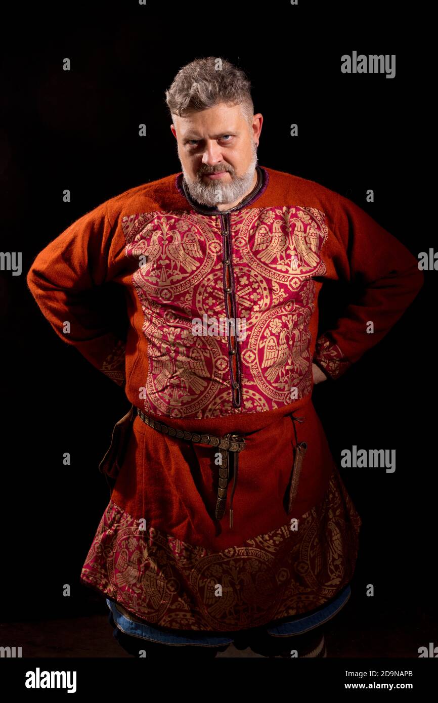 Mature bearded man in traditional historic clothes studio portrait ...