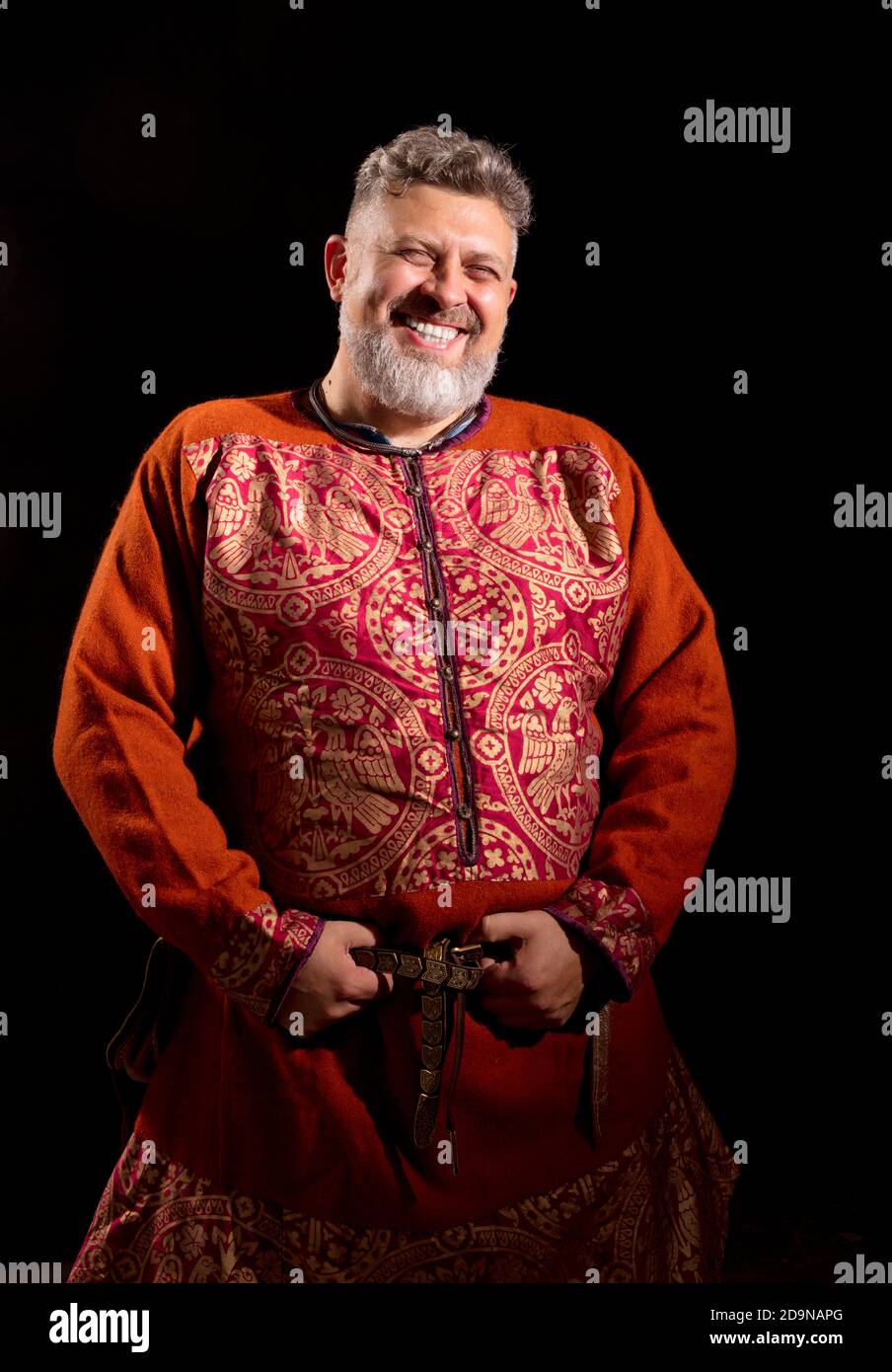 Mature bearded man in traditional historic clothes studio portrait ...