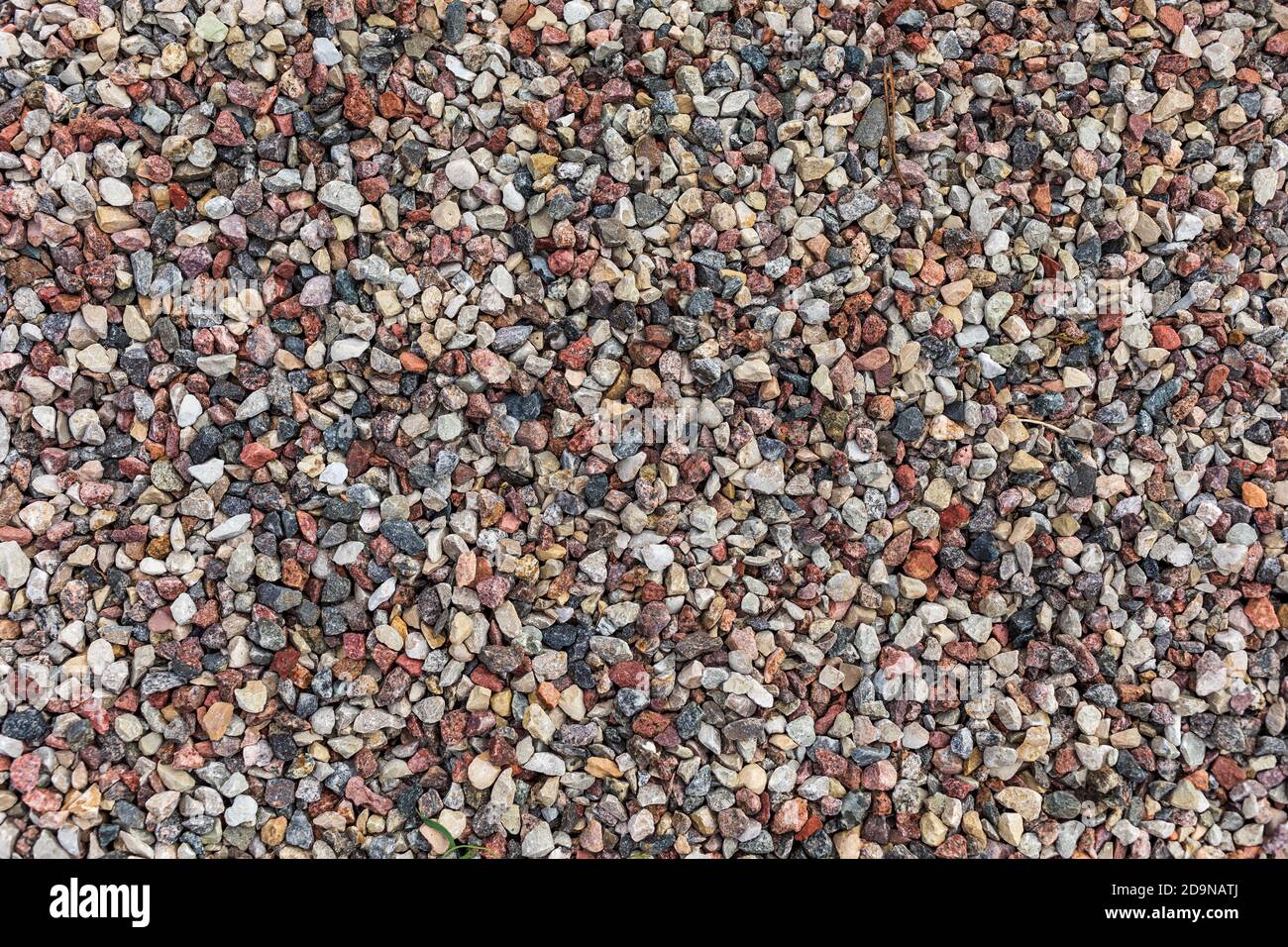 Different colored rocks and pebbles on a beach. Various colors and ...