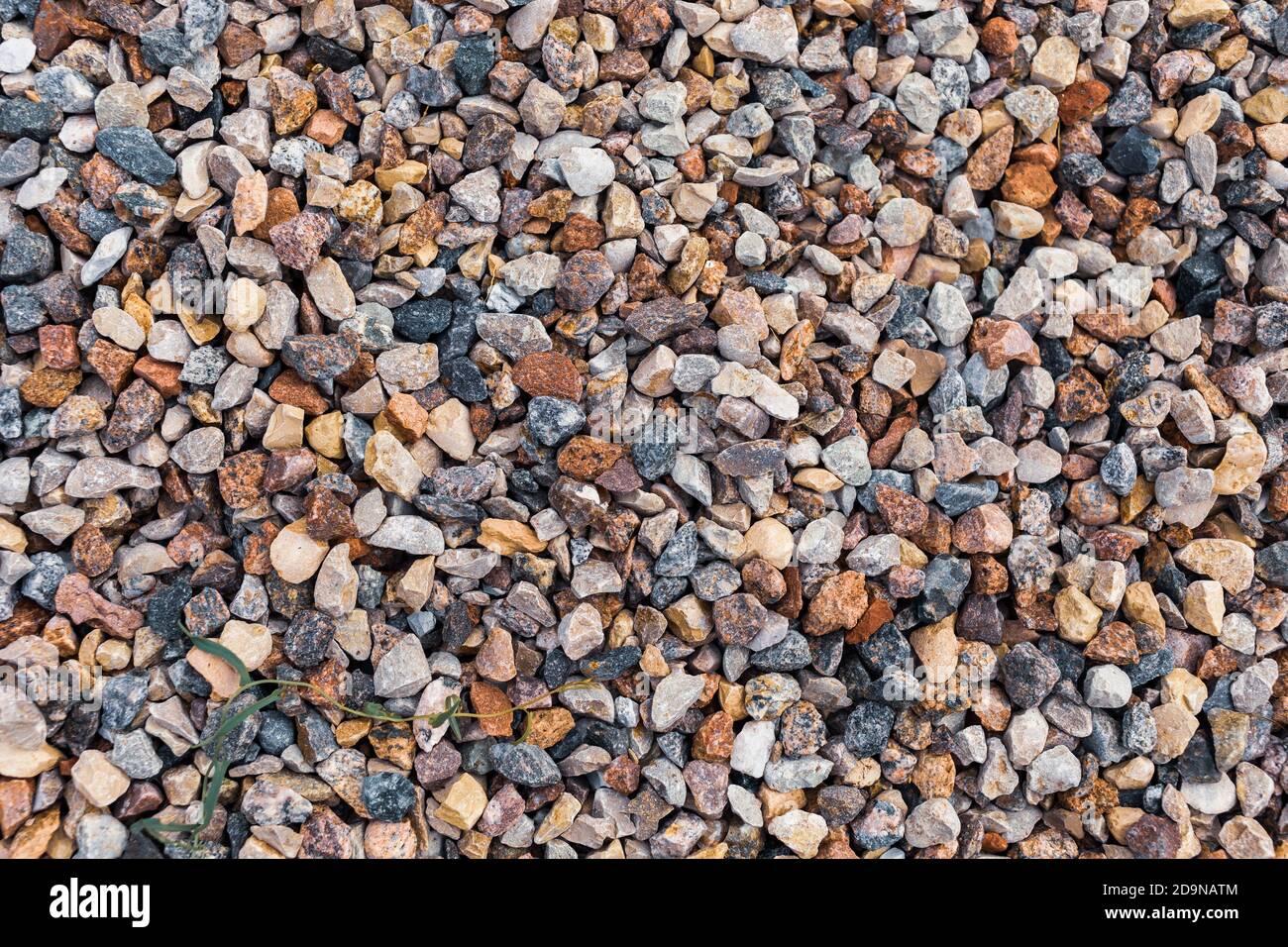 Different colored rocks and pebbles on a beach. Various colors and ...