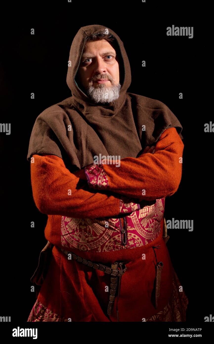 Mature bearded man in traditional historic clothes studio portrait ...